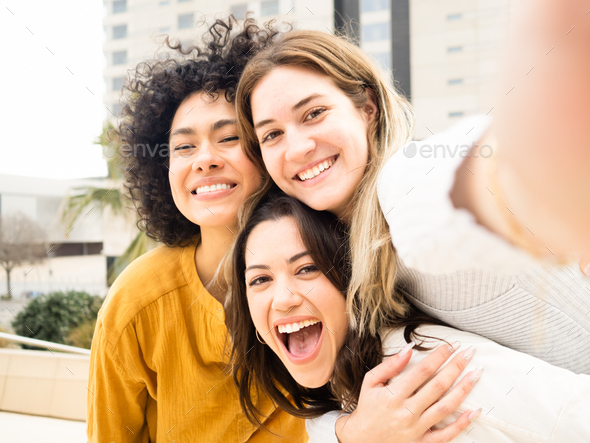 Smiling multiethnic young women having fun. Friends have fun. Stock Photo by gonzagon